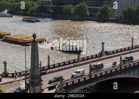 Cory tug boats transporting waste containers past the Houses of ...