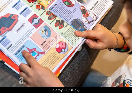 Children reading Pokemon book Stock Photo - Alamy