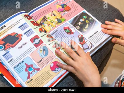 Children reading Pokemon book Stock Photo - Alamy