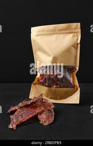 A Pile of Black Pepper Beef Jerky on a Rustic Wooden Table Stock Photo ...