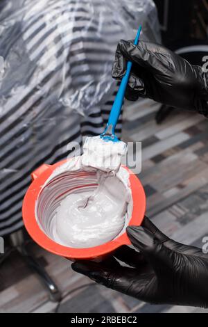 Hair coloring process mixing ingredients brush paint container dye ...