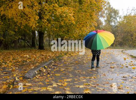 under a large yellow and orange umbrella on the sunny beach symbol of ...