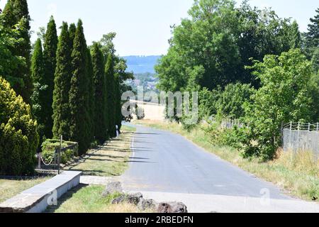 Small country road or street with blue sky background Stock Photo - Alamy