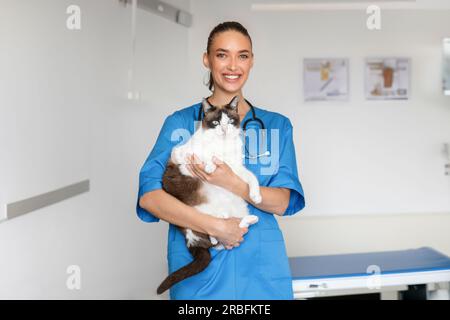 Happy young professional veterinary doctor with purebred welsh pembroke ...