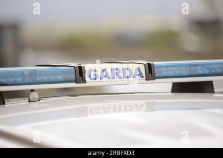 Garda/Irish Police sign and blue lights on a Garda/Police car with copy ...