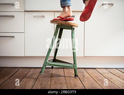 Man falls from stool Stock Photo - Alamy