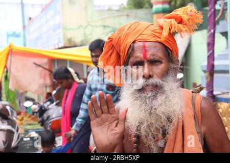 A tractor is on work. A baba is showing his hands like praising the ...