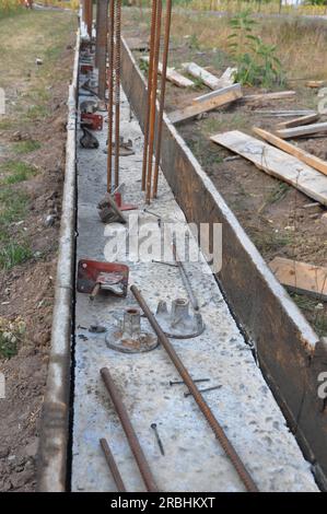 A close-up of the concrete footing in concrete forms with reinforcement ...