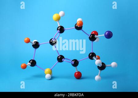 Structure of molecule on light blue background, closeup. Chemical model ...