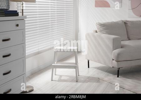 White compact ladder near window at home Stock Photo - Alamy