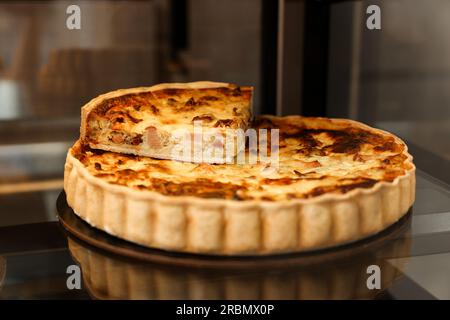 Delicious meat quiche on counter in bakery shop, closeup Stock Photo ...
