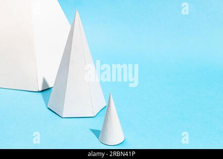 handmade paper pyramids close up on turquoise blue background Stock ...