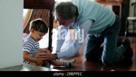 Empathic grandfather consoling hurt child grandparent reaching for ...