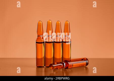 Medical ampules on orange background Stock Photo - Alamy