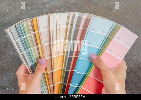 Color selection according to RAL. A woman designer chooses a shade from ...