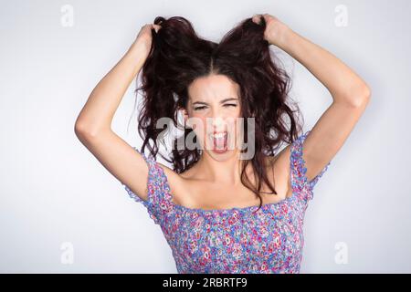 A dark haired model screaming, showing emotion Stock Photo - Alamy