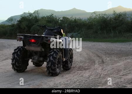 Modern fast quad bike on pathway outdoors Stock Photo - Alamy