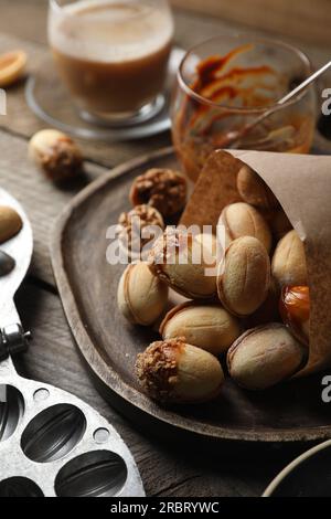 Homemade walnut shaped cookies with boiled condensed milk on white ...