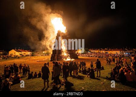People watch the burning of the loyalist Corcrain bonfire in Portadown ...