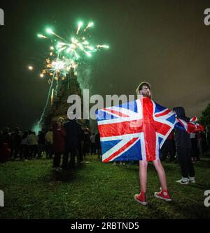 People watch the burning of the loyalist Corcrain bonfire in Portadown ...