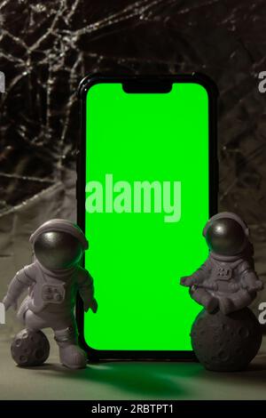 Plastic toy figure astronaut with mobile phone white screen for your ...