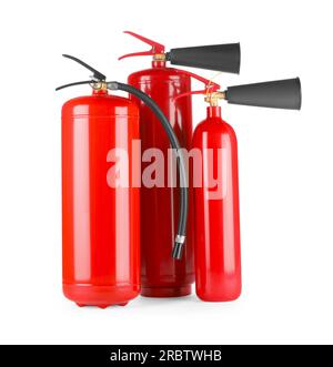Three red fire extinguishers on white background Stock Photo - Alamy