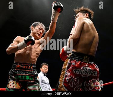 Jin Sasaki (red gloves) and Hiroto Hoshi (black gloves) compete during ...