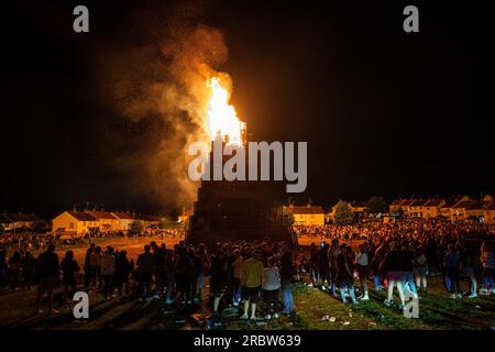 People watch the burning of the loyalist Corcrain bonfire in Portadown ...