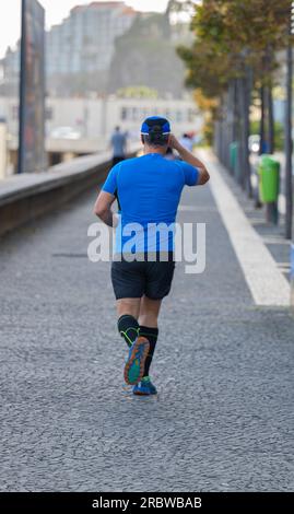 man playing sports on the boardwalk Stock Photo - Alamy