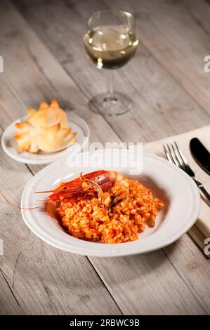 Raw fish fillets are in a glass dish with lemon and lime slices, carrot ...