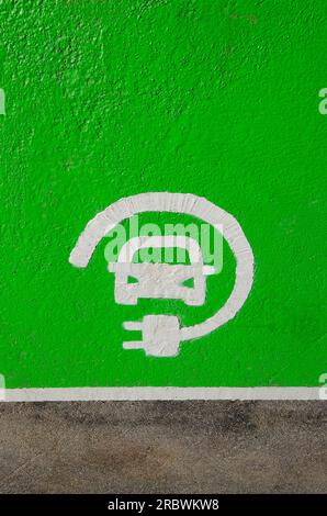 A electric vehicle charging bay and parking spot with a symbol of an ...