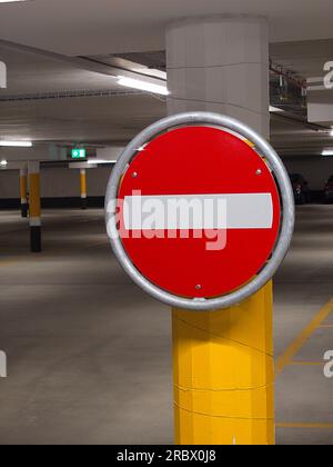 A traffic sign prohibiting car parking (red cross on blue circle) with ...