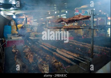 “Porceddu” Small Roasted Pig on the spit, “Cordula” made up of braided ...