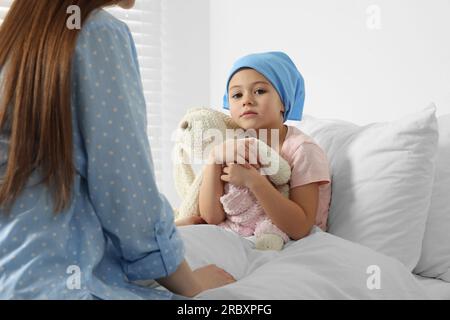 Childhood cancer. Mother and daughter with toy bunny in hospital Stock ...
