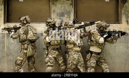 Squad of soldiers running forward and attacking enemy during military ...