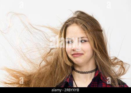 Girl with heavily flowing hair on white background Stock Photo - Alamy