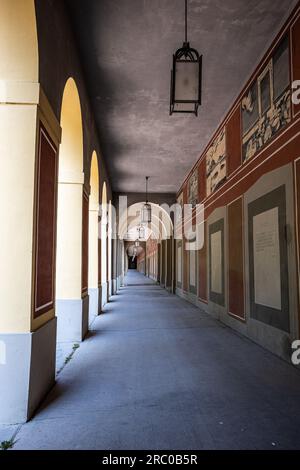 Promenade with long arcade columns surrounding Hofgarten Park in Munich ...