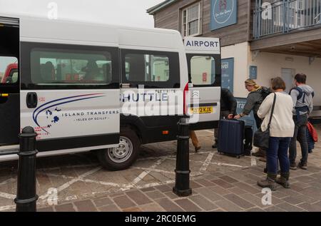 Passengers boarding a shuttle bus from Pegasus airplane to airport on ...
