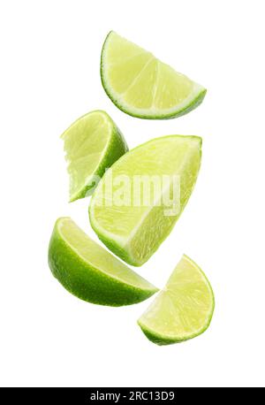 Fresh lime slices falling on white background Stock Photo - Alamy