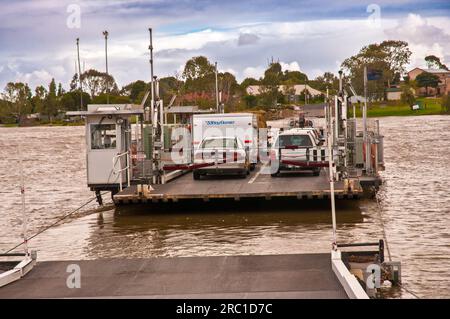 Vehicular ferry crossing Murray River with car on board & reflected in ...