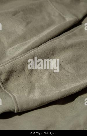 Lints on green sweater. Before cleaning and collected fluff lint ...