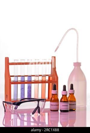 Rack with test tubes, plastic bottle, pipette vials with chemicals ...