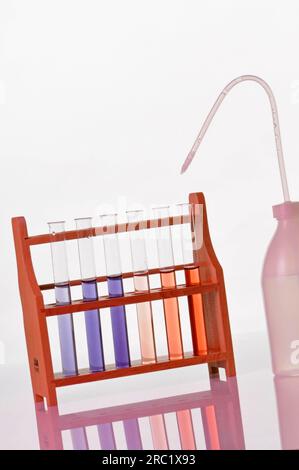 Rack with test tubes, plastic bottle, pipette vials with chemicals ...