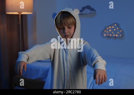 Boy in pajamas sleepwalking indoors at night Stock Photo - Alamy