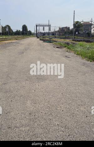 Paved road next to railroad tracks and a railroad station in the ...