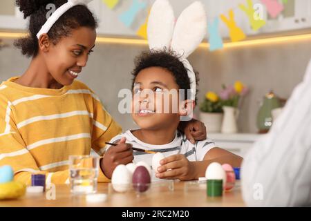 mom and son in bunny ears celebrate easter, play in the playhouse ...
