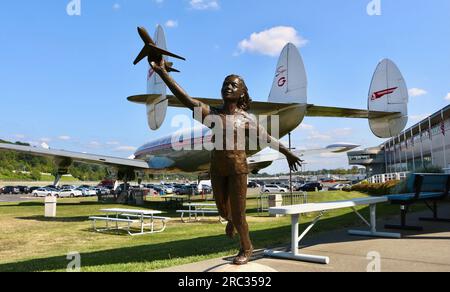 Bronze statue of a child with a Boeing 747 Jumbo Jet standing on the ...