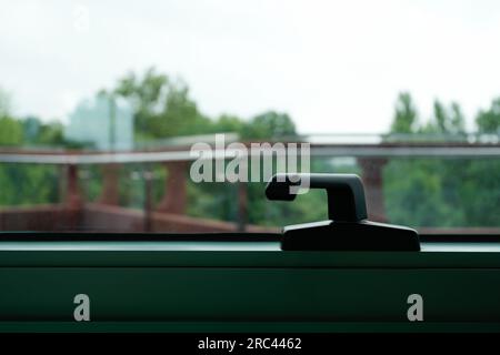 A window handle, used to lock, open, or close a window Stock Photo - Alamy