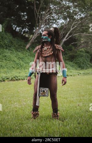 Confident braided male Mayan warrior in traditional costumes and body ...