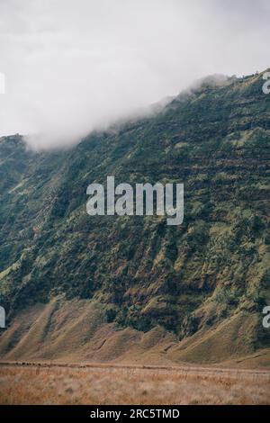 Close up shot of Bromo hills in fog. Foggy Bromo mount volcano ...